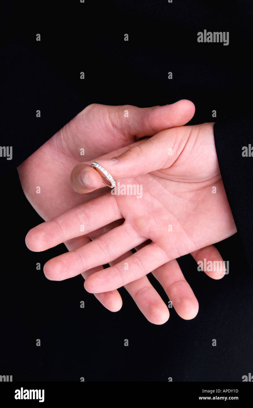 Groom with ring behind back Stock Photo - Alamy