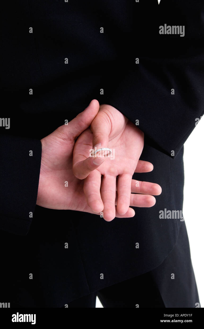 Groom with ring behind back Stock Photo - Alamy