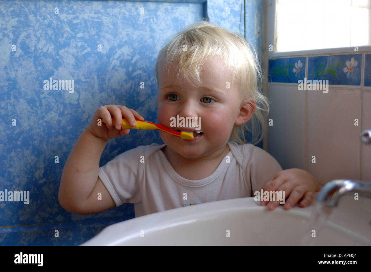 A two year old girl brushing her teeth Stock Photo - Alamy