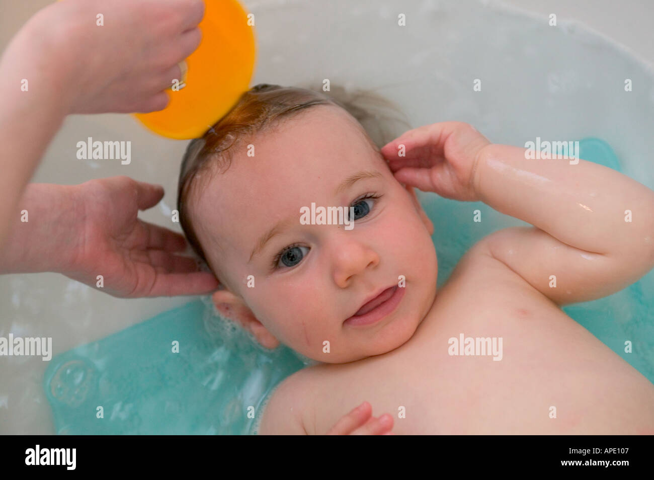 Mother washing baby Stock Photo - Alamy