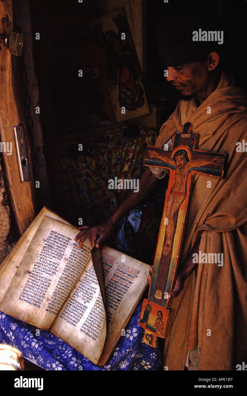 Monk with painted cross and ancient bible in a monastery on an island ...