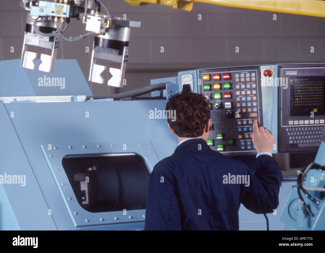 Engineer operates manufacturing robot Stock Photo - Alamy
