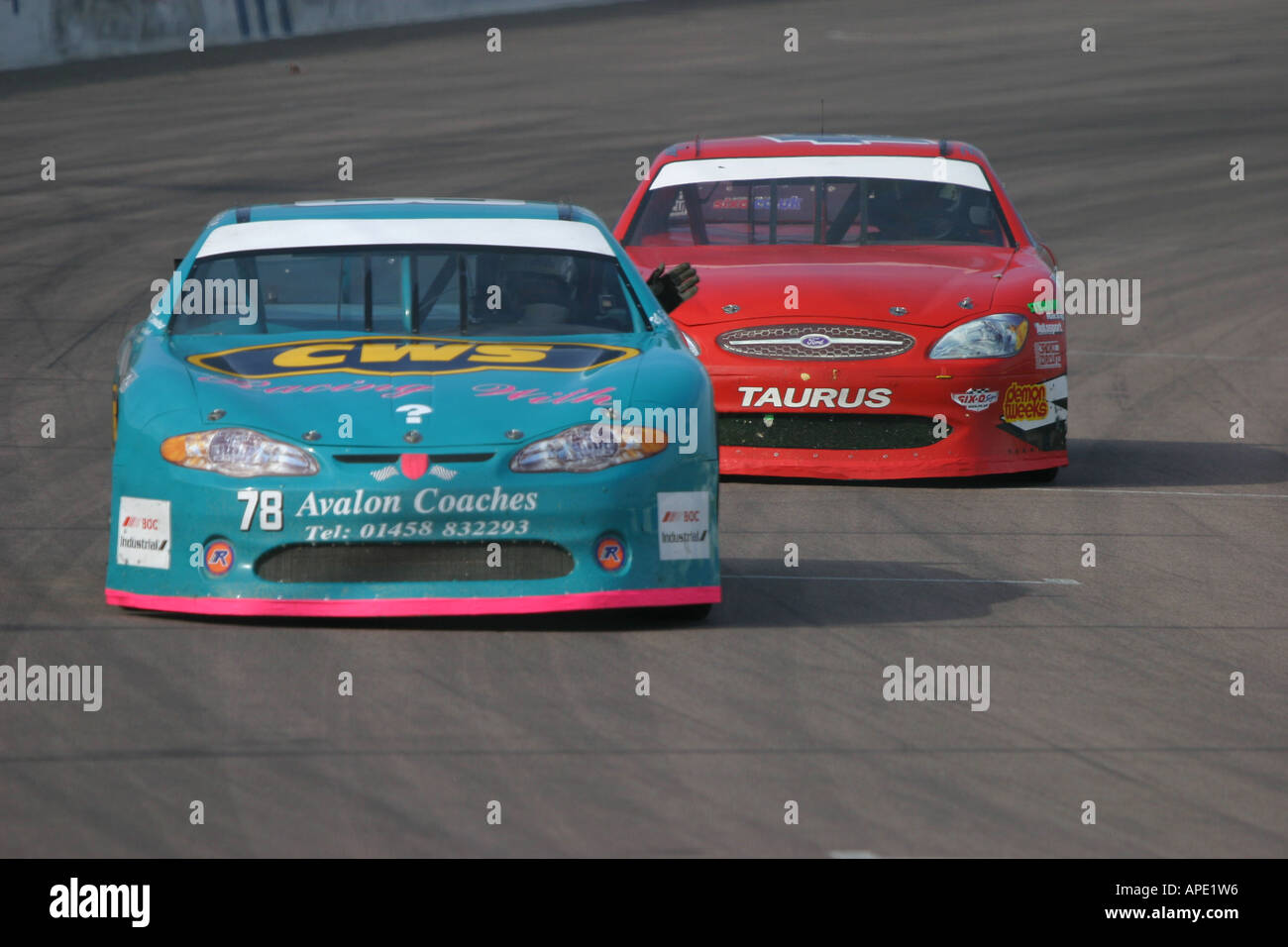 V8 Nascar type stock cars racing on a banked oval circuit Stock Photo ...