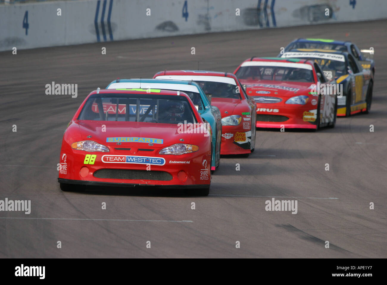 V8 Nascar type stock cars racing on a banked oval circuit Stock Photo ...