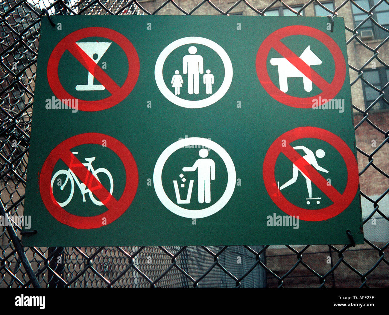 Pictograms on a fence in a park describe prohibited and allowed ...