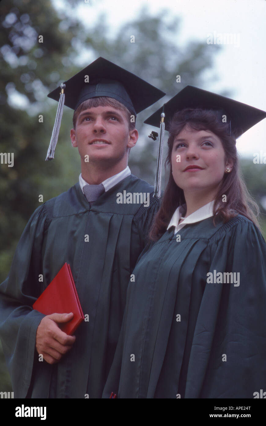 Graduates couple, gown, caps,pose Stock Photo - Alamy