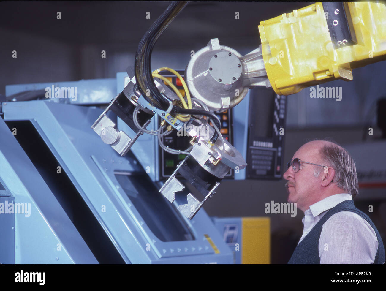 Operator inspects robot-computer Stock Photo - Alamy