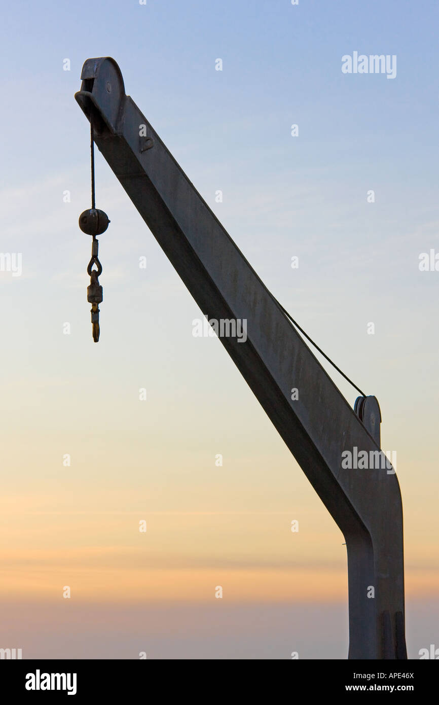 Jib of crane at harbourside with dusk light behind Stock Photo - Alamy