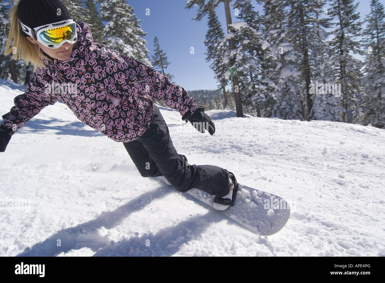 A woman snowboarding on a groomed run at Northstar ski area near Lake ...