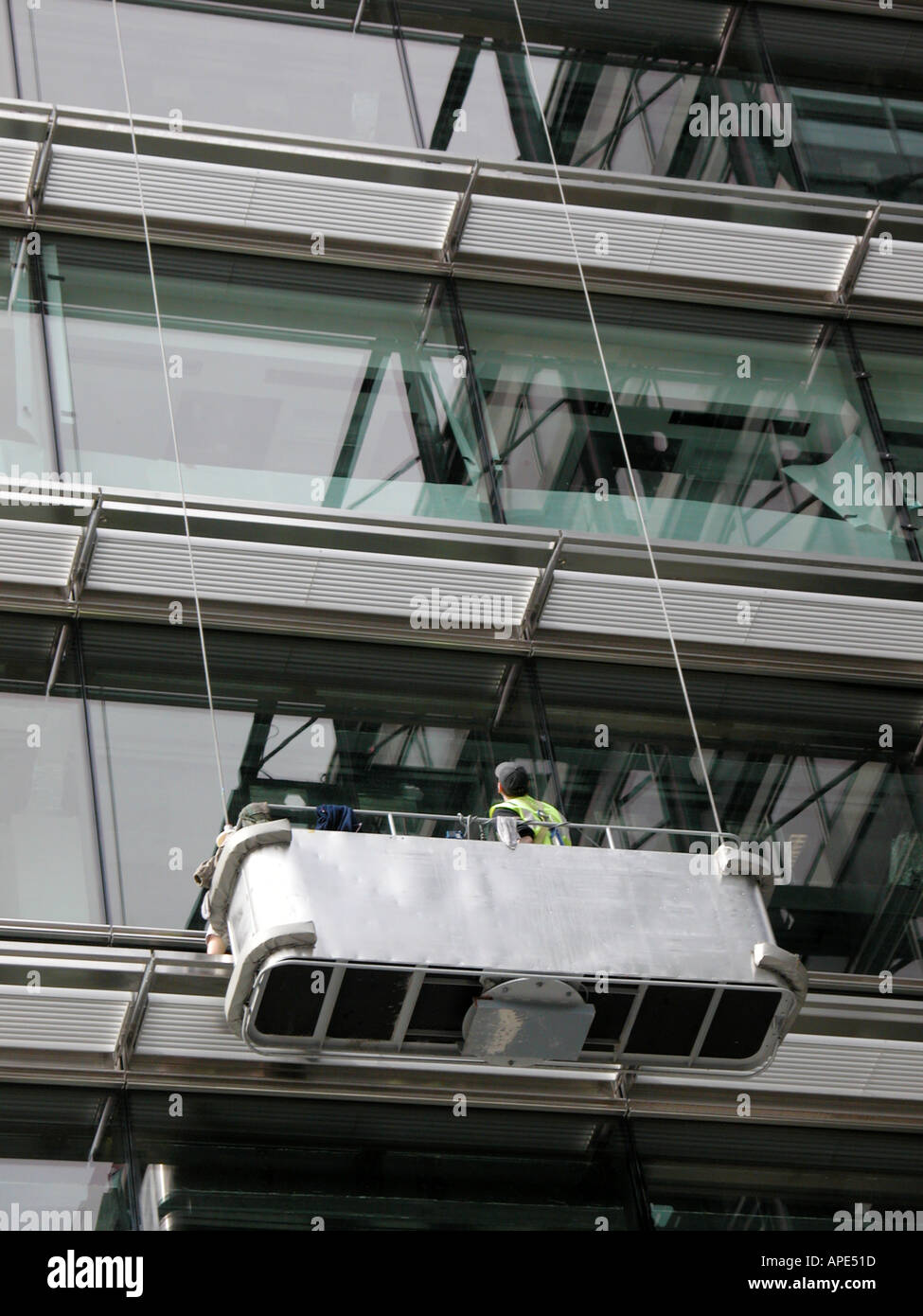 window cleaners in a cradle in the Broadgate Centre City of London ...