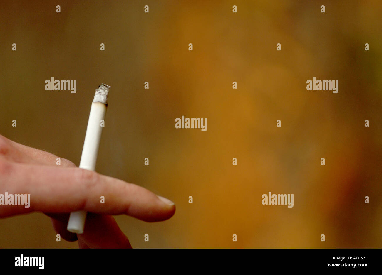 Horizontal color image of a mans hand holding a cigarette Stock Photo ...