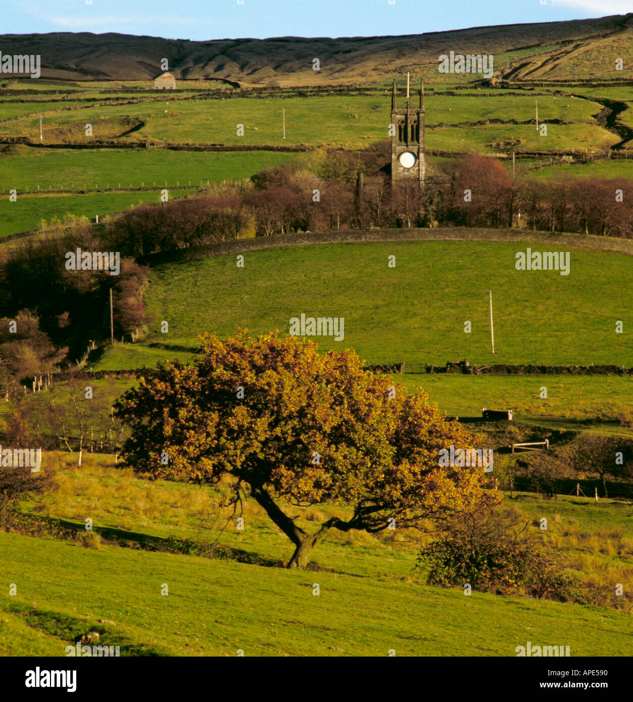 Saddleworth Church seen over fields with the moors beyond, near ...