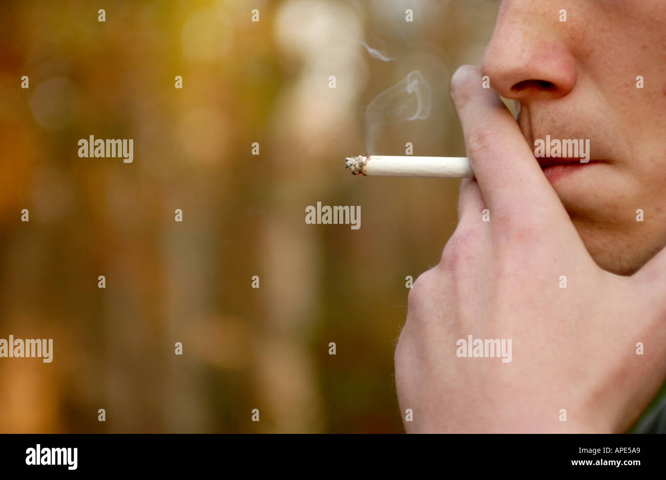 Horizontal color image of a teenage male smoking a cigarette Stock ...
