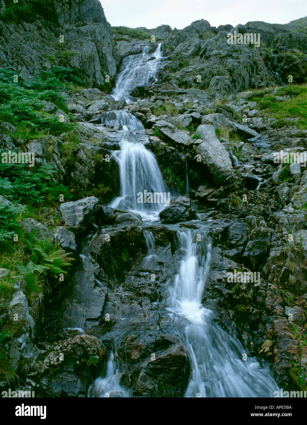 Waterfall tumbling over rocks above Haweswater, Lake District National ...