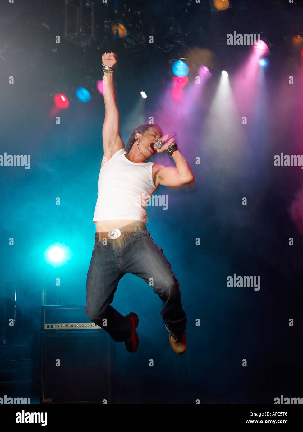 Young Man Singing and jumping on stage at concert, low angle view Stock ...