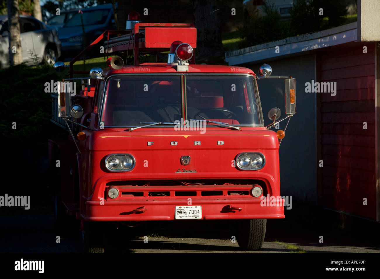 A red firetruck sits in the shade on a summer day Stock Photo - Alamy