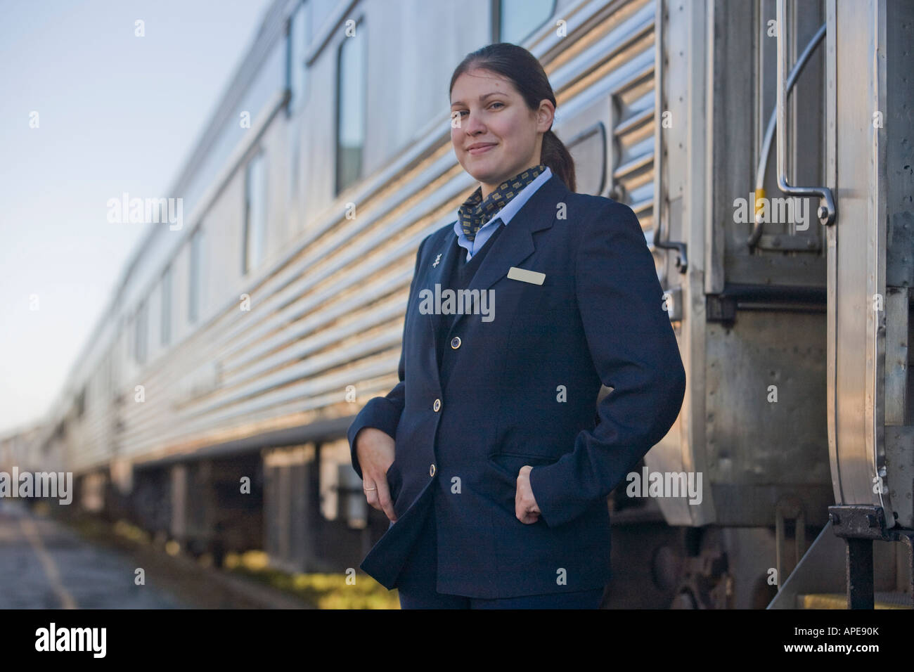 A conductor stands in front of her train Stock Photo - Alamy