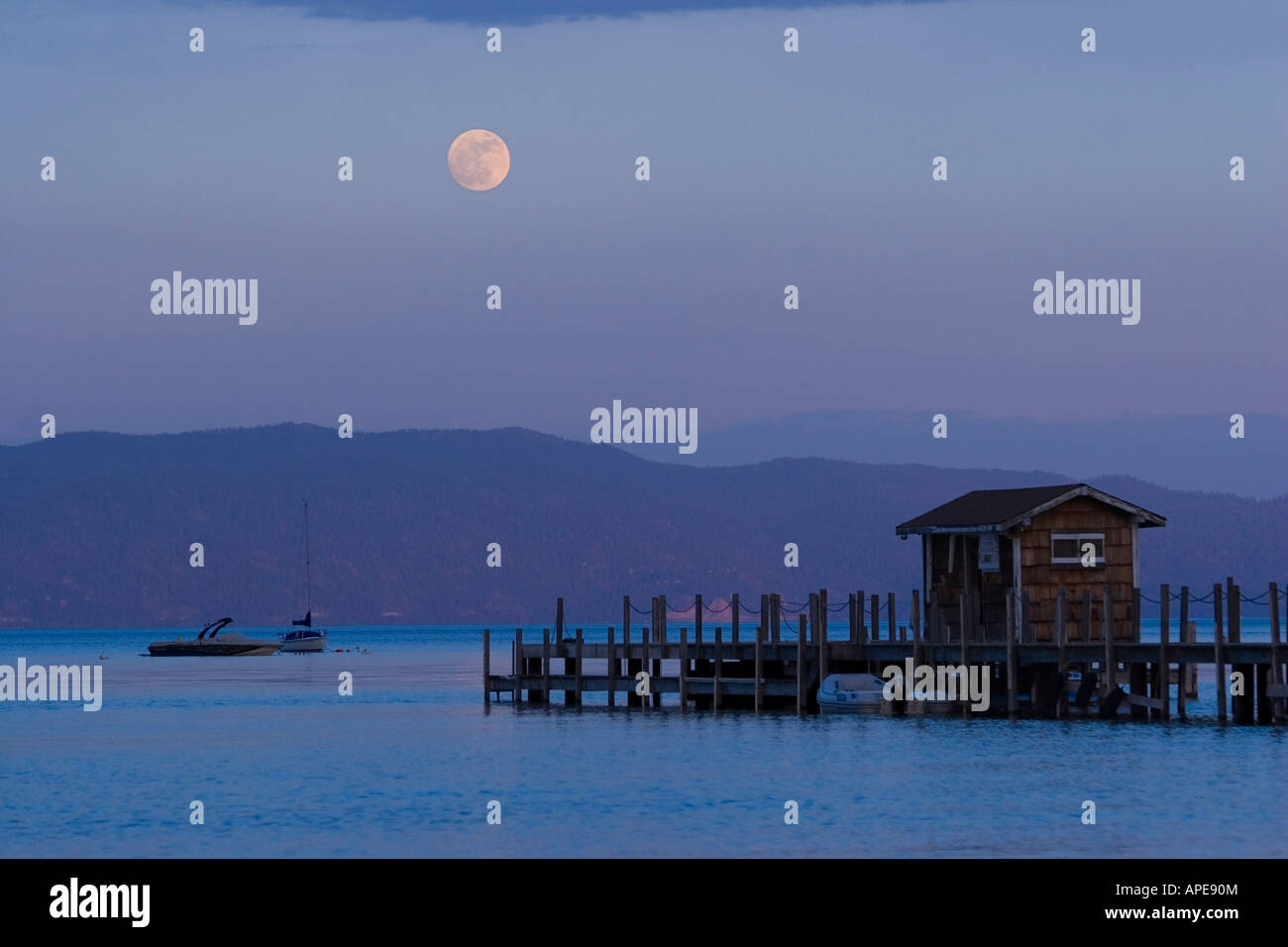 The full moon rising over Lake Tahoe, California and a pier Stock Photo ...