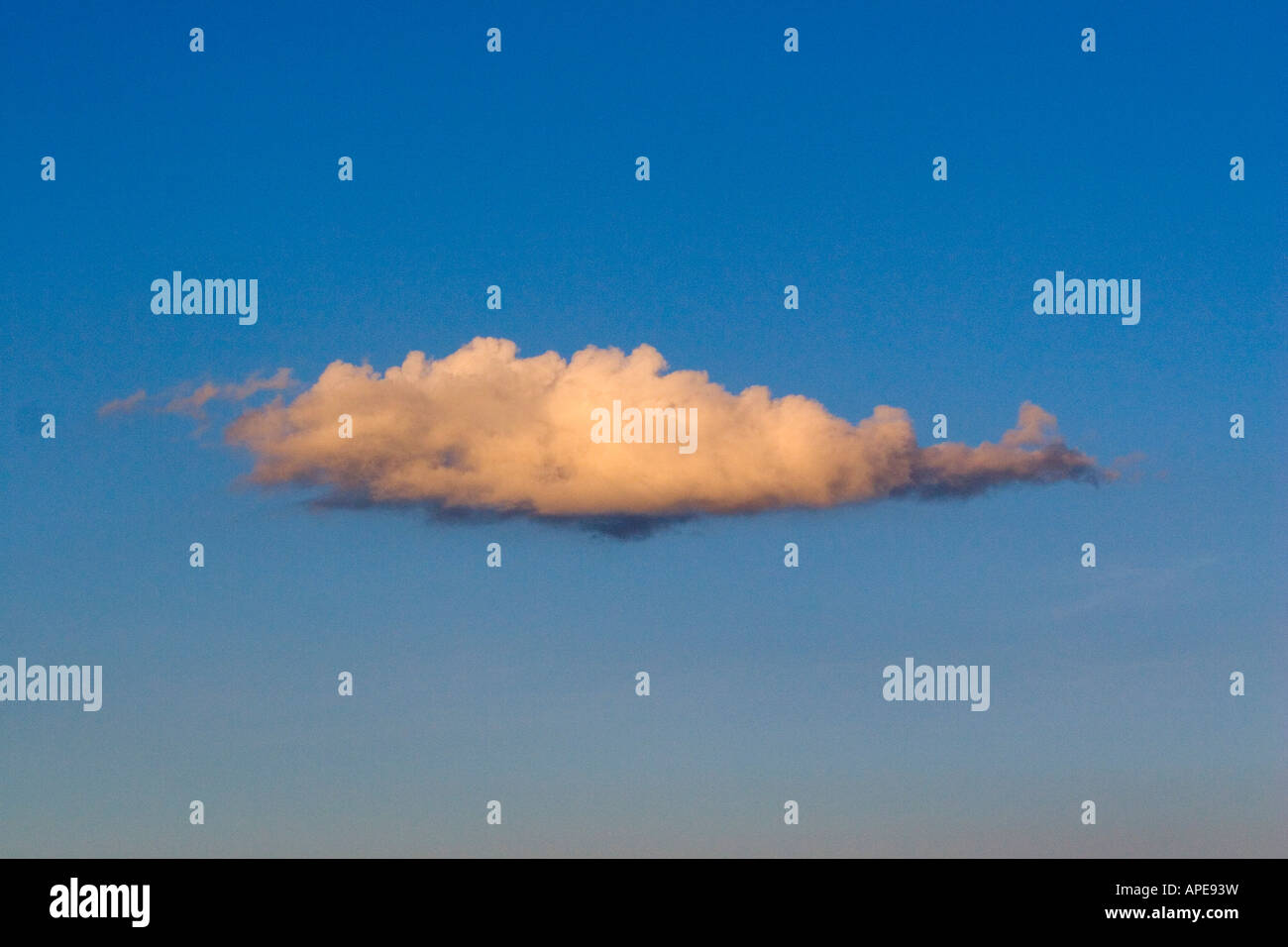 A lone cumulous cloud in a blue sky Stock Photo - Alamy