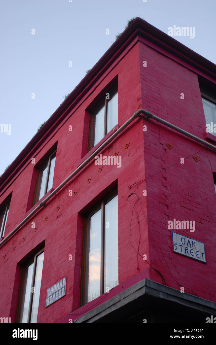 building painted red with windows portrait Stock Photo - Alamy