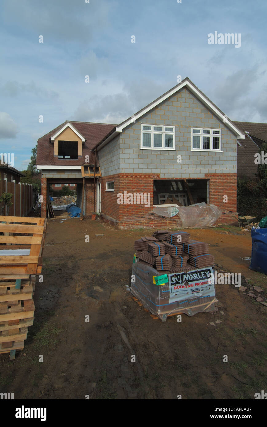 Building plot with new detached house under construction scaffolding ...