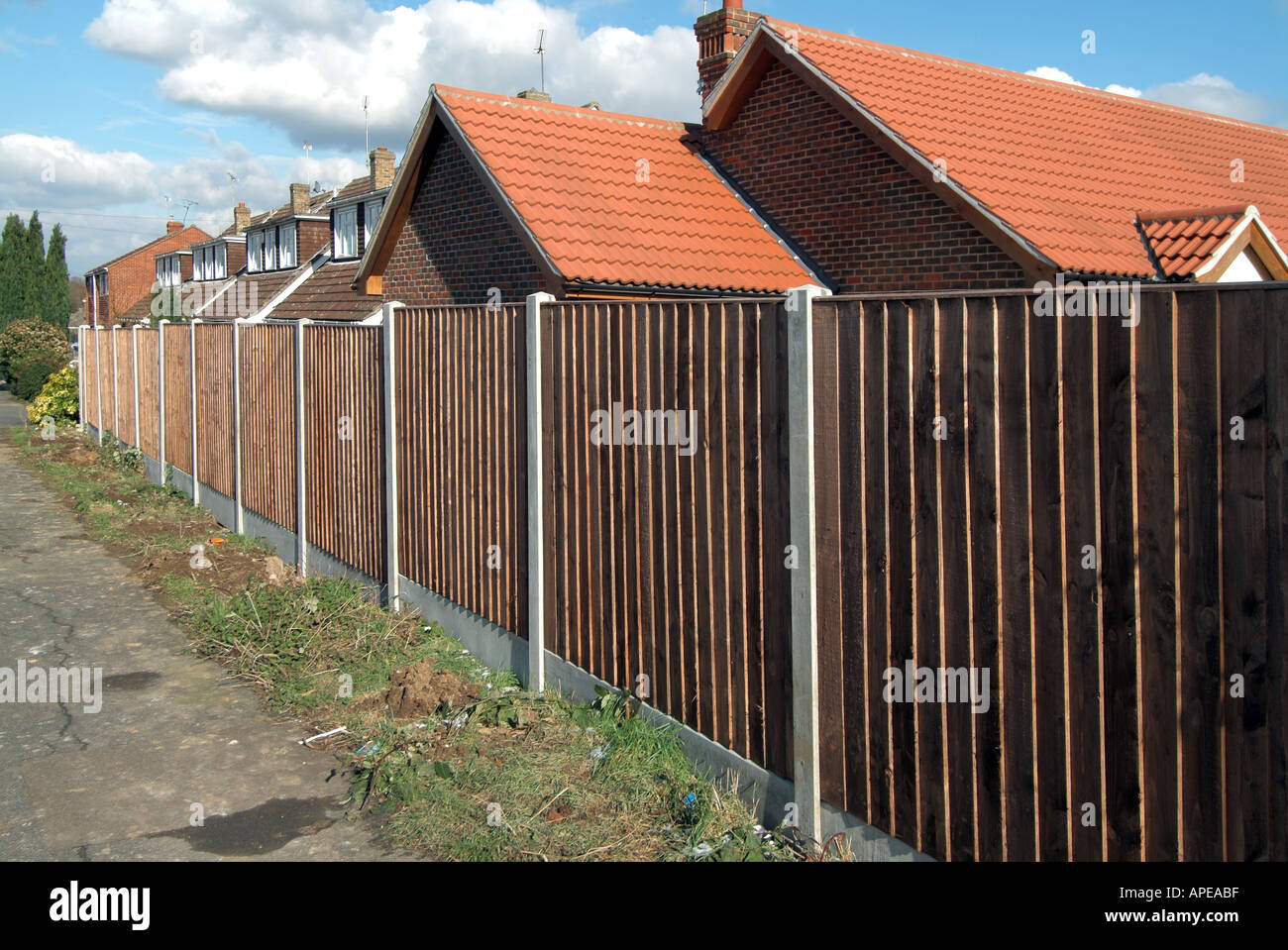 Residential street with new standard timber fence panels along back ...