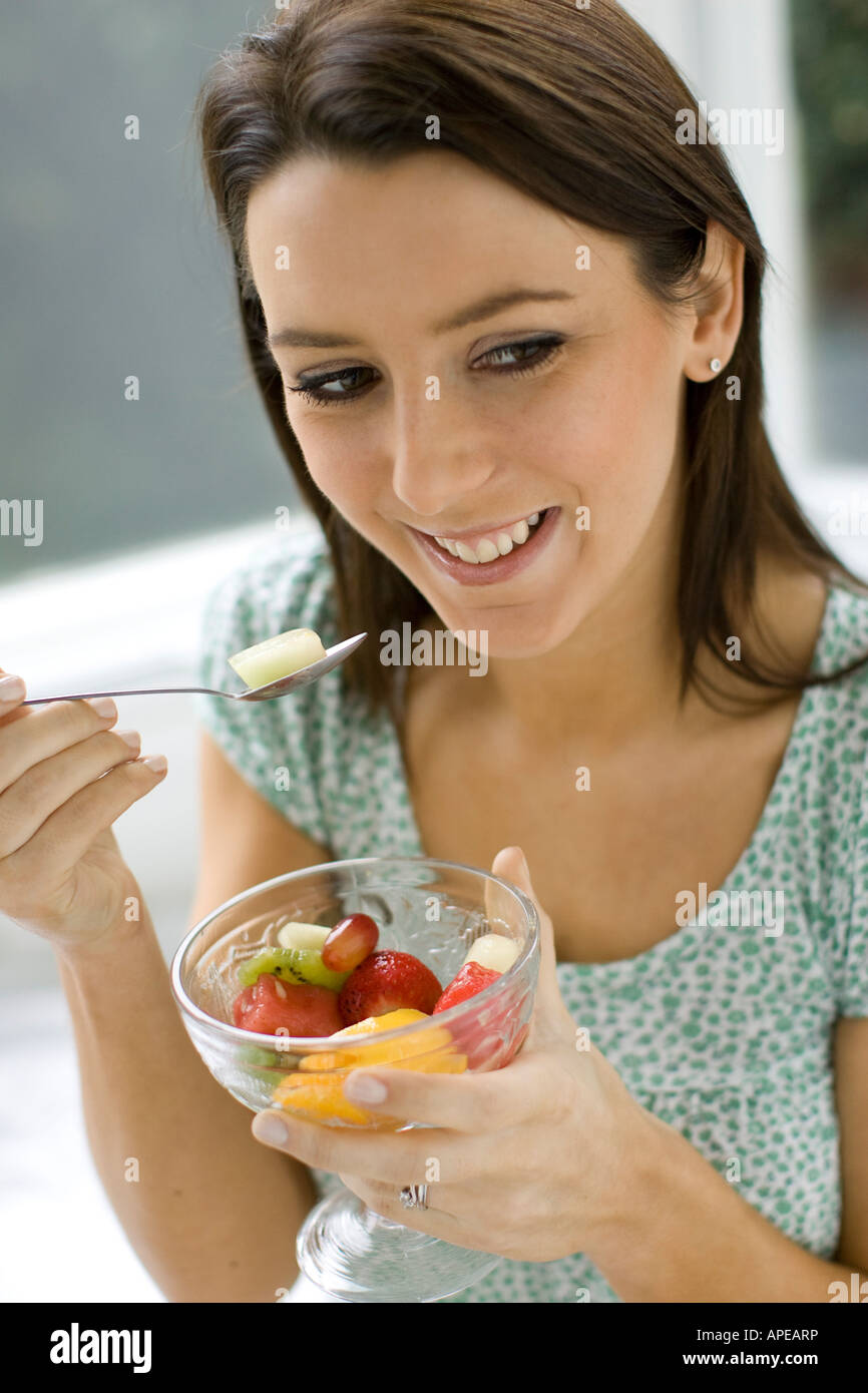 Girl eating fruit Stock Photo - Alamy