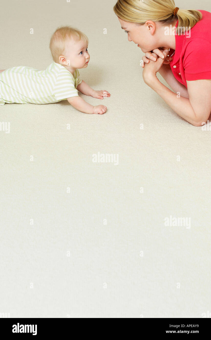 Mother and child lying on floor Stock Photo - Alamy