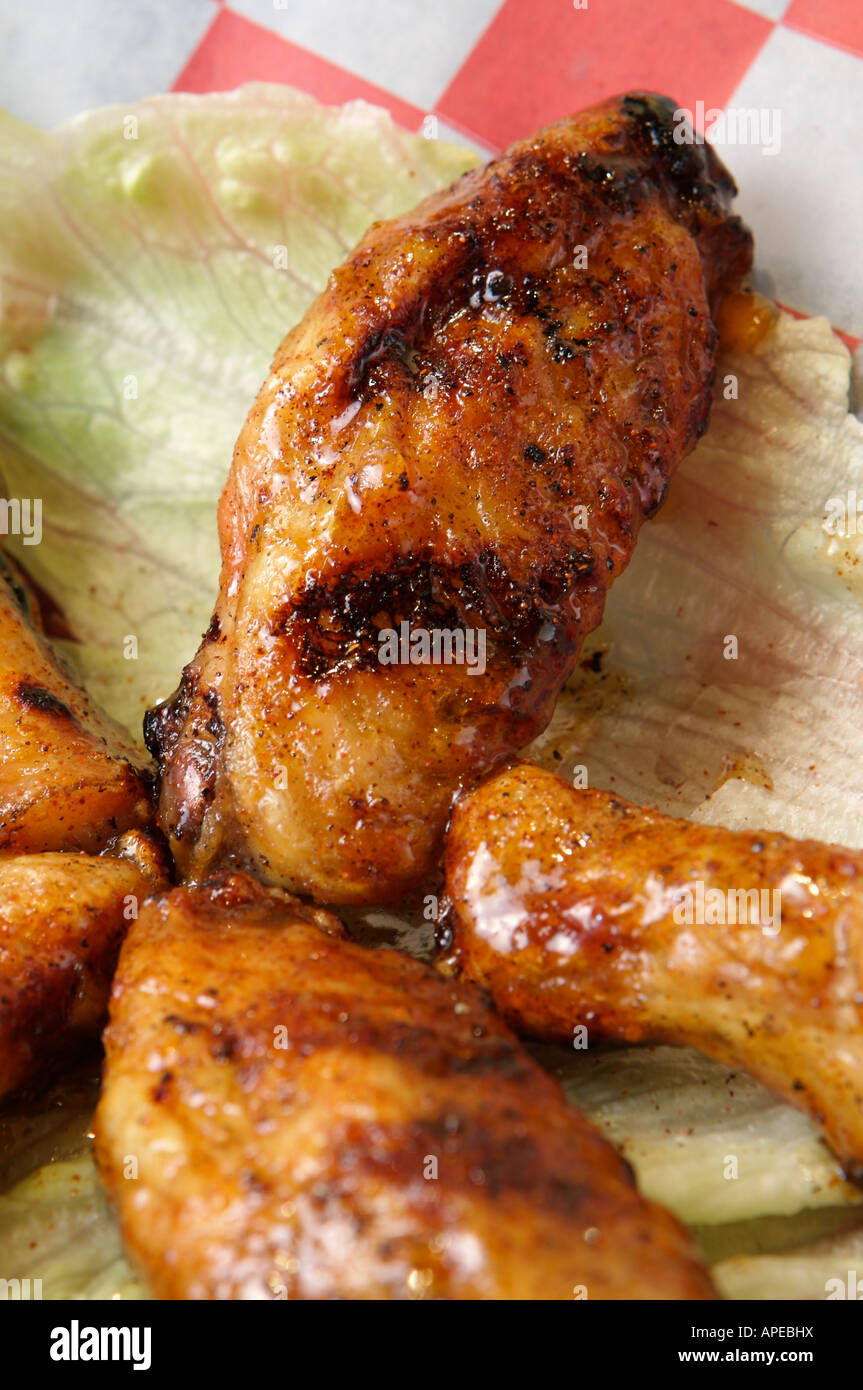 Chicken wings in a fast food basket on top of lettuce Stock Photo - Alamy