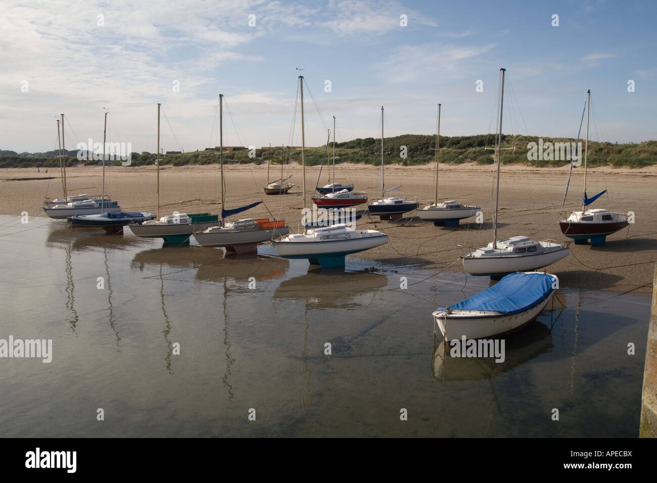 Sailing boats moored on the beach at Beadnell, Northumberland, England ...