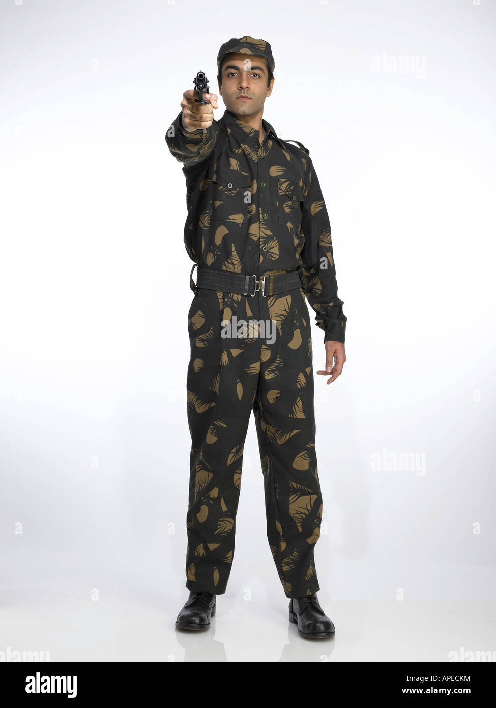 Indian army soldier standing in relaxed position aiming handgun Stock ...