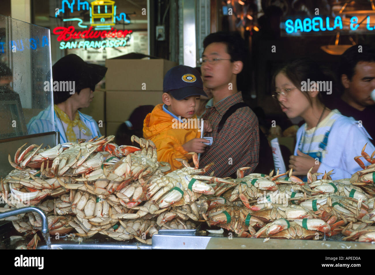 Asian oriental family and cooked crabs at sidewalk seafood shop store ...