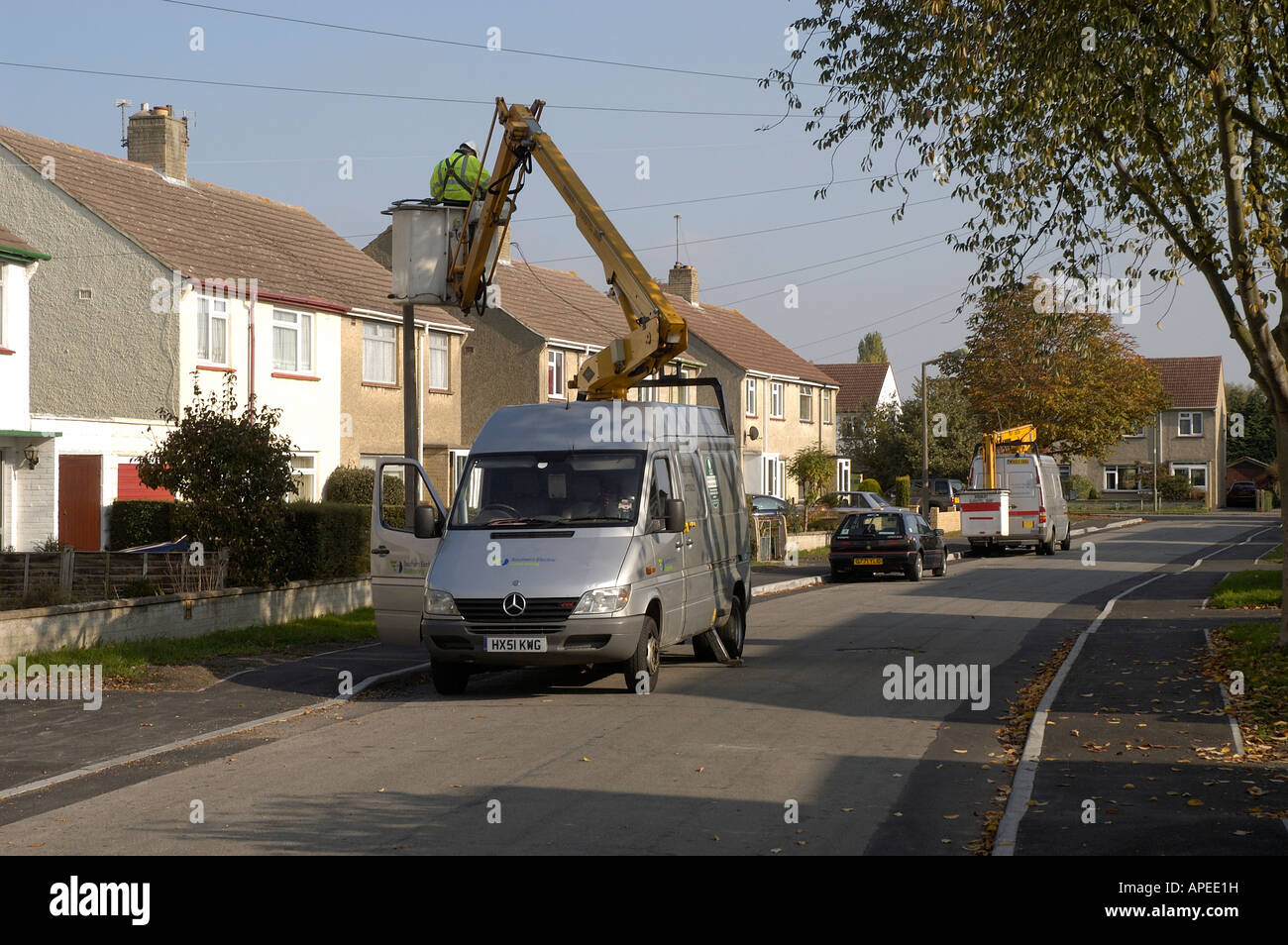 maintenance worker working on street lighting using a cherry picker ...