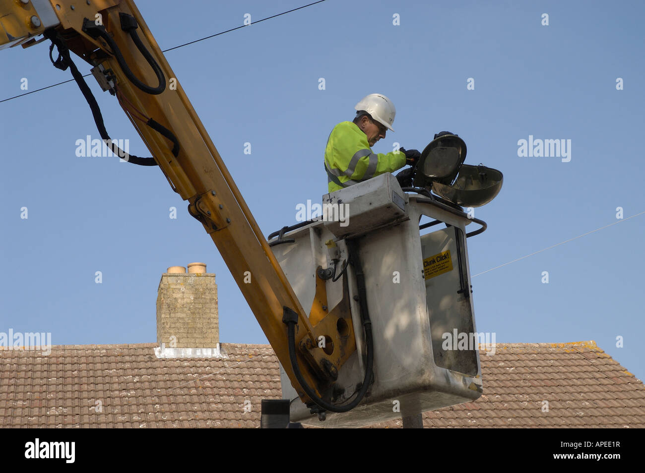 maintenance worker working on street lighting using a cherry picker ...