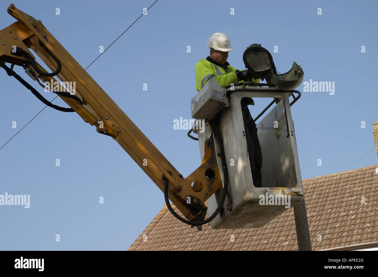 maintenance worker working on street lighting using a cherry picker ...