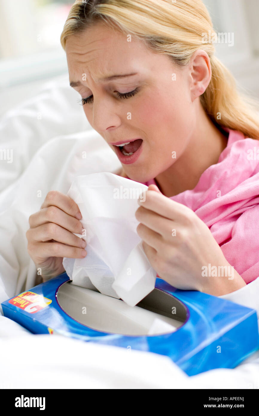 Girl with cold blowing nose Stock Photo - Alamy