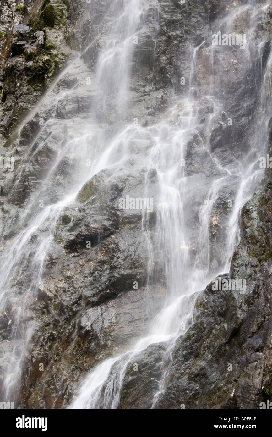 A close view of a waterfall falling over rocks in the backwoods Stock ...