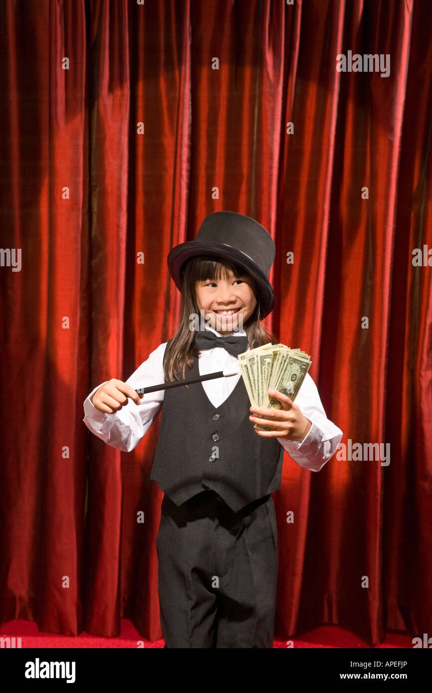 Asian girl performing magic trick on stage Stock Photo - Alamy