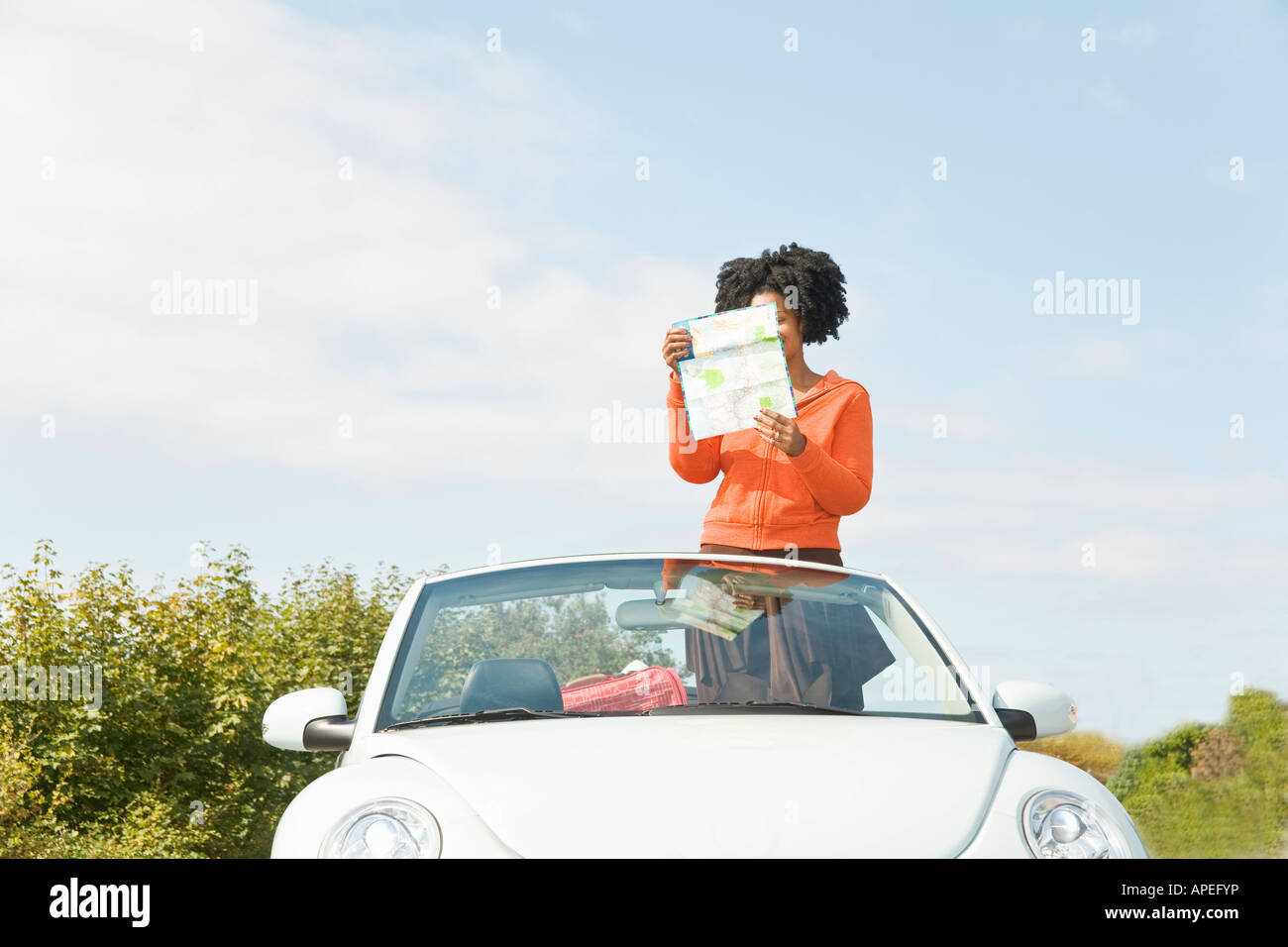 African woman reading map in convertible car Stock Photo - Alamy