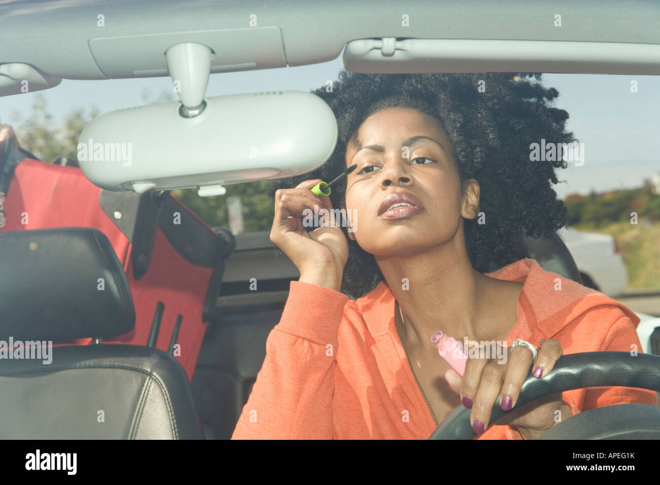 Woman applying mascara driving hi-res stock photography and images - Alamy