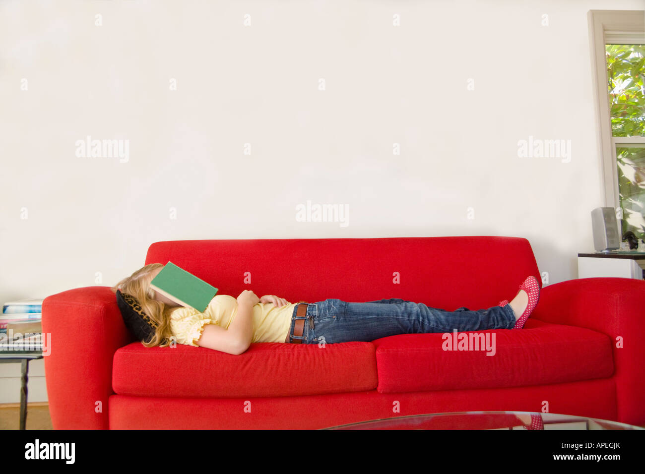 Teenage girl with book over face Stock Photo - Alamy