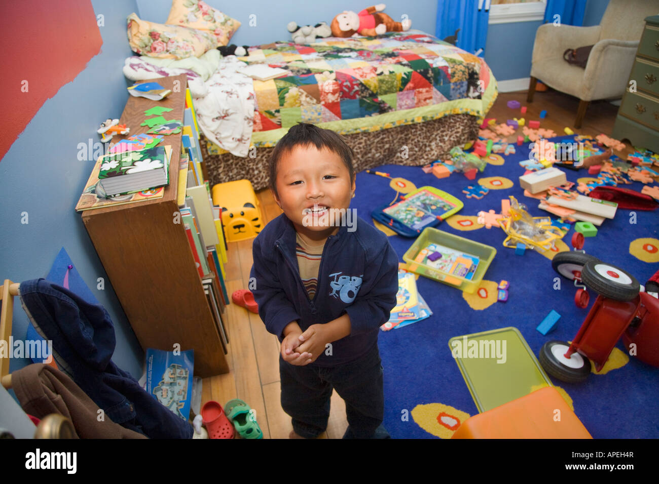 Asian boy in messy bedroom Stock Photo - Alamy