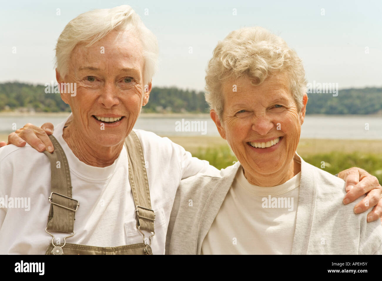 Senior women hugging outdoors Stock Photo - Alamy