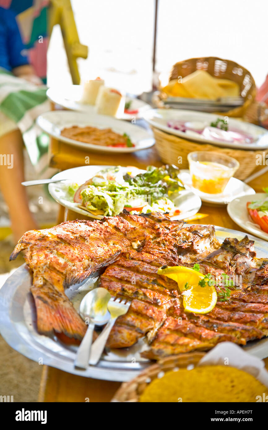 Table filled with plates of food Stock Photo - Alamy
