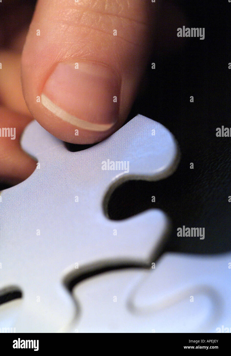 placing puzzle piece Stock Photo - Alamy