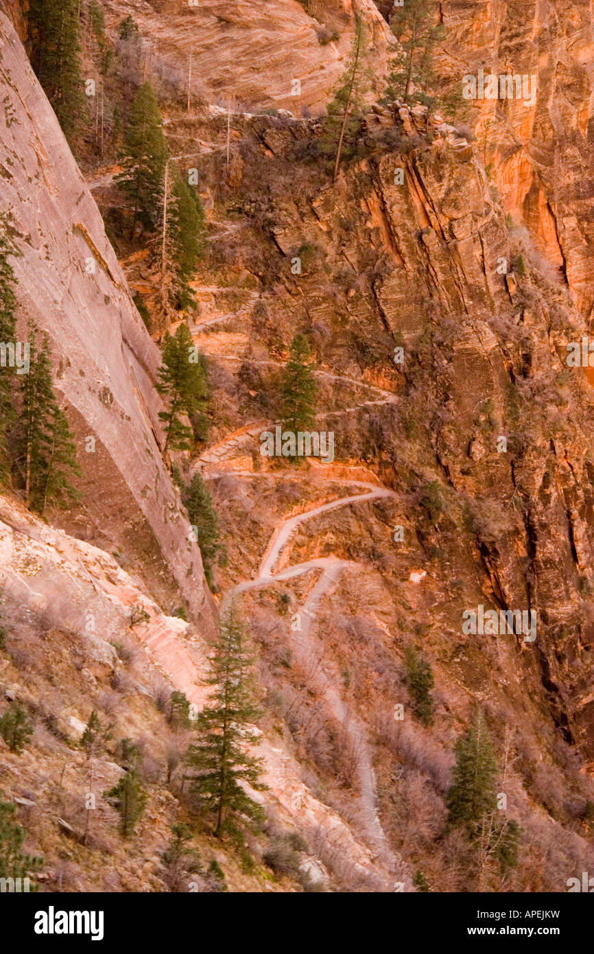A trail rises up a steep cliff face to a hidden canyon behind the wall ...