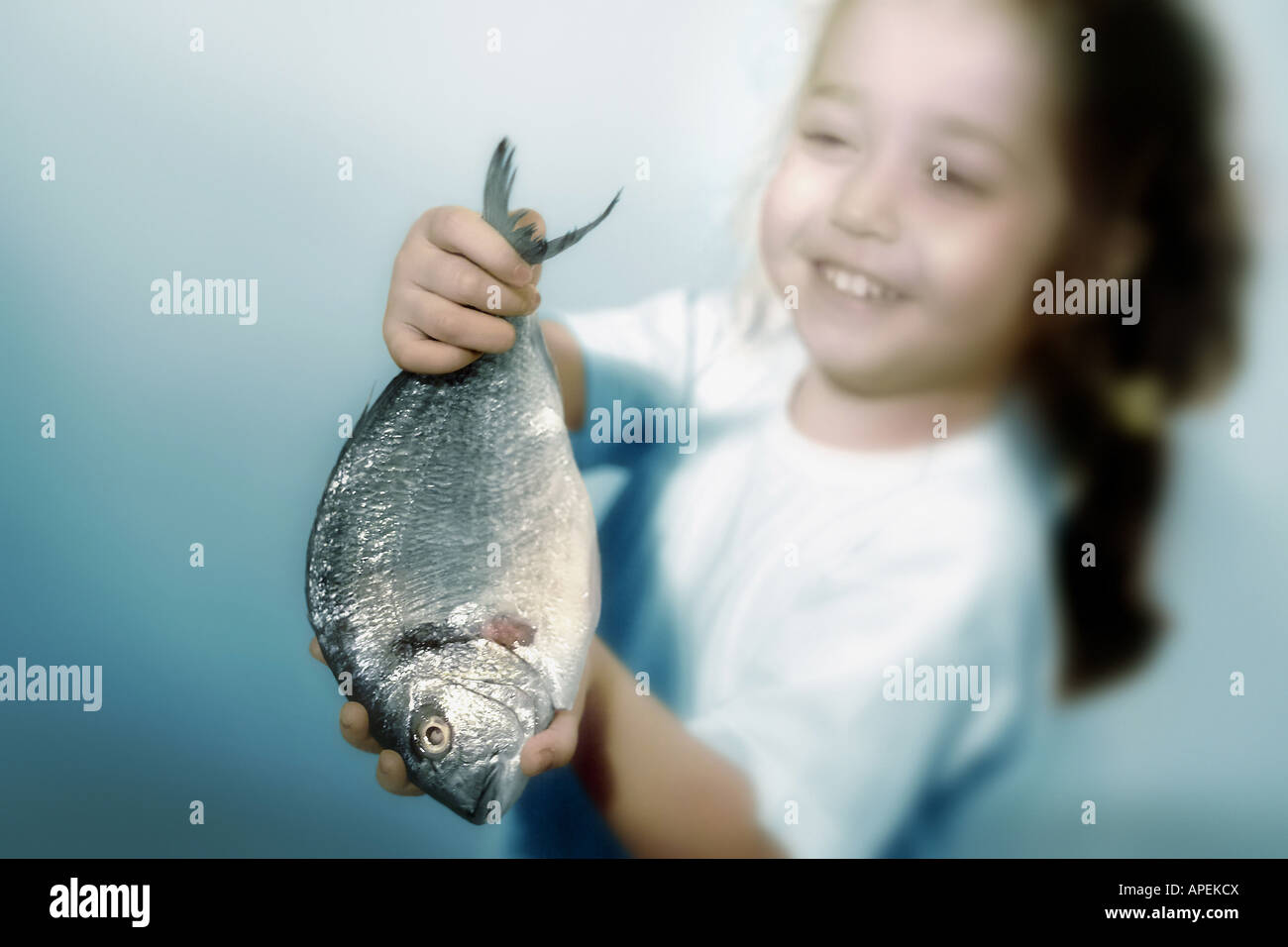 Girl with fish Stock Photo - Alamy