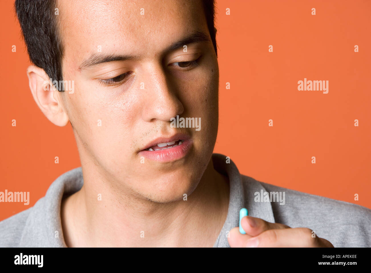 Portrait Latino man holding pharmaceutical capsule Stock Photo - Alamy