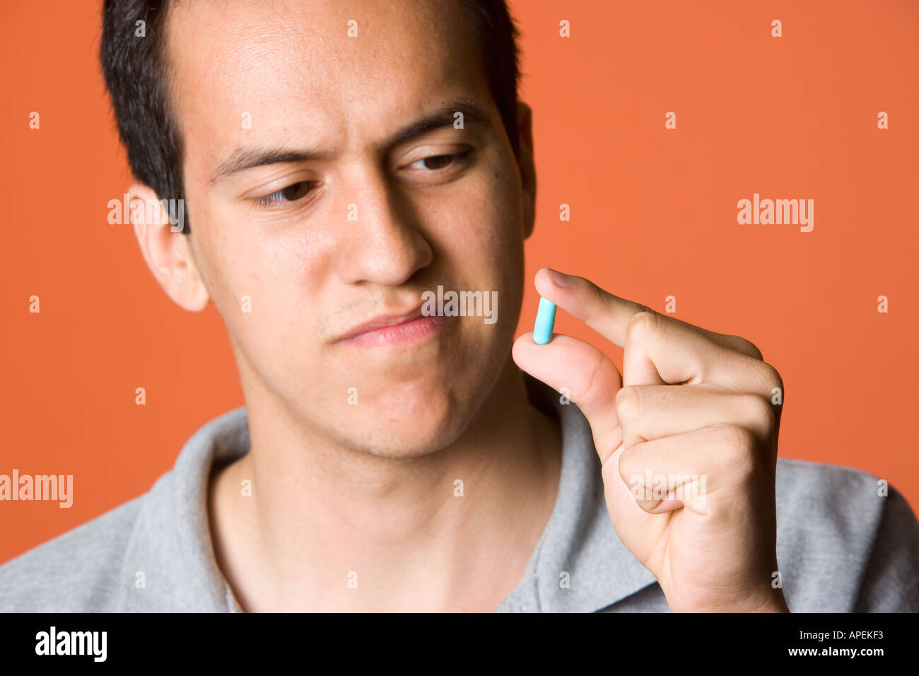 Portrait Latino man holding pharmaceutical capsule Stock Photo - Alamy