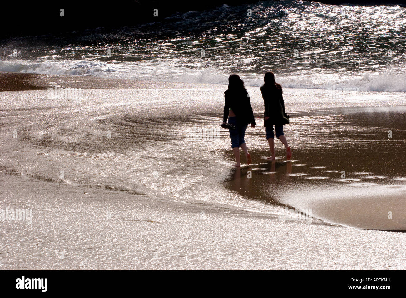 Girl friends walk on beach Stock Photo - Alamy